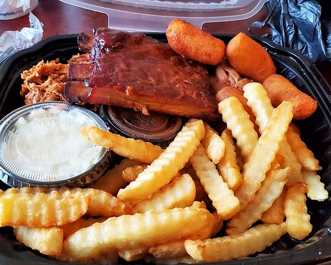 A half-rack of ribs that's seen just the right amount of smoke, accompanied by the supporting cast of fries and slaw.