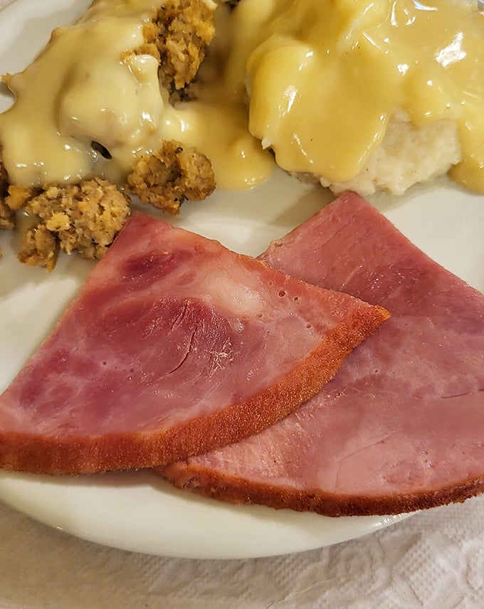 Ham, mashed potatoes, and stuffing—the holy trinity of comfort food. This plate doesn't just feed your body; it hugs your soul from the inside.
