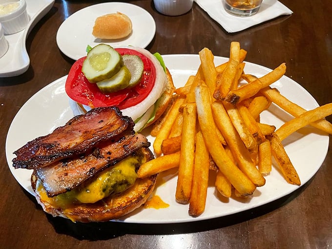 Burger perfection isn't complicated: quality beef, melty cheese, crisp vegetables, and bacon that should win awards. Those fries aren't just sides—they're co-stars.