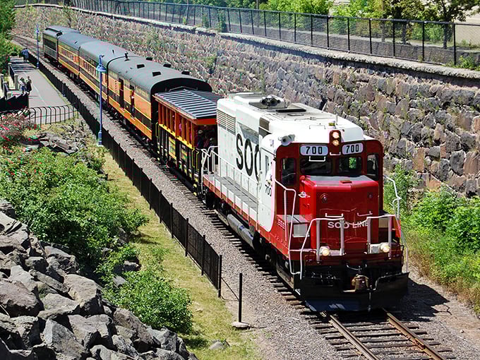The workhorse of the North Shore line cuts a striking silhouette against Minnesota's summer landscape – industrial poetry in motion.