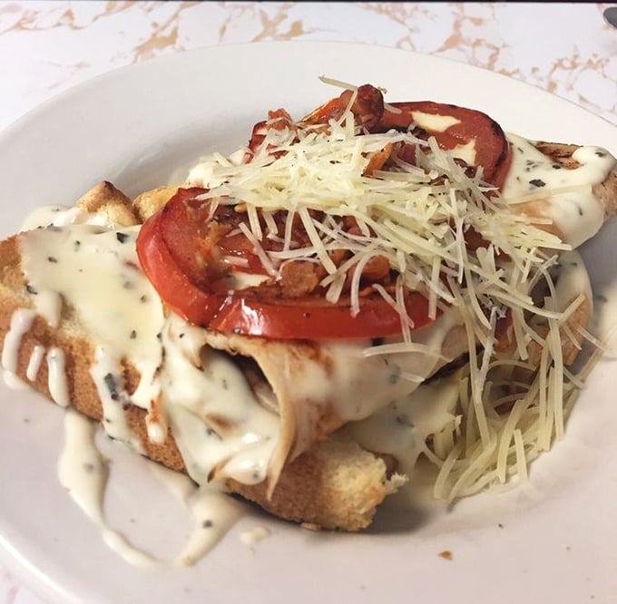 The Kentucky Hot Brown – an open-faced masterpiece that proves cheese sauce and bacon can elevate any dish from good to "where has this been all my life?"
