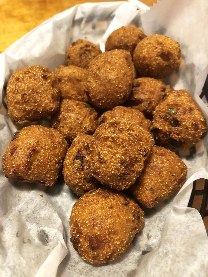 Golden-brown hush puppies that crunch then yield, the perfect Southern sidekick that refuses to be overshadowed by the main attraction.
