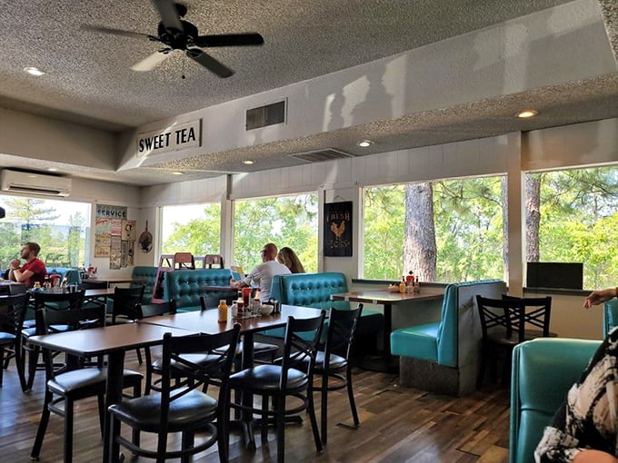 Bright windows, turquoise booths, and "SWEET TEA" signage—this dining room feels like a hug from your favorite aunt who really knows how to cook.