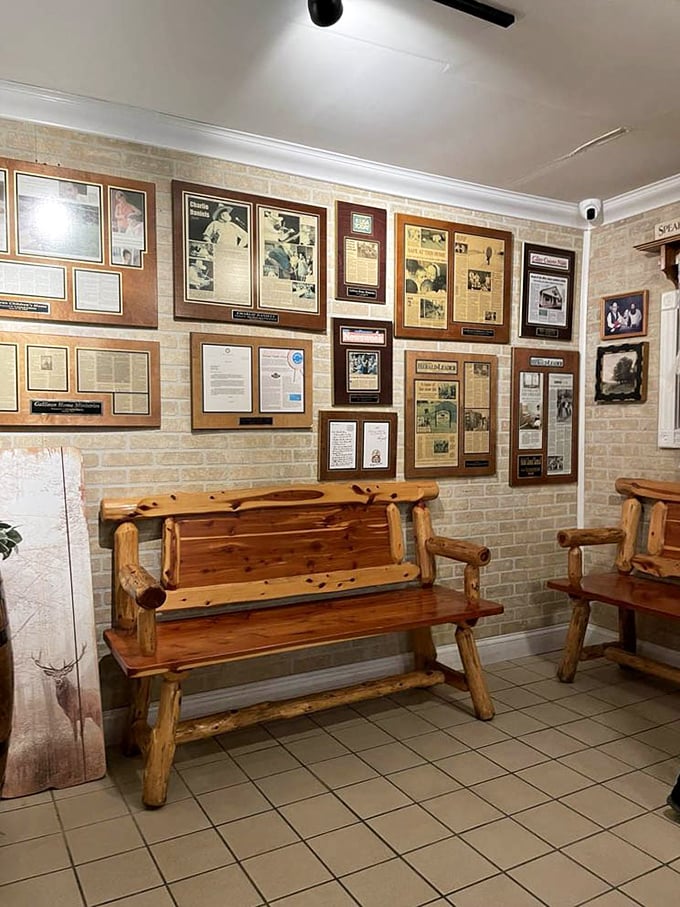 The walls tell stories while you eat—framed memories and rustic wooden benches create a waiting area that feels more like a family room.