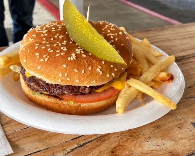 The jumbo cheeseburger with its pickle spear standing at attention like a sentry guarding a treasure of beef and cheese.