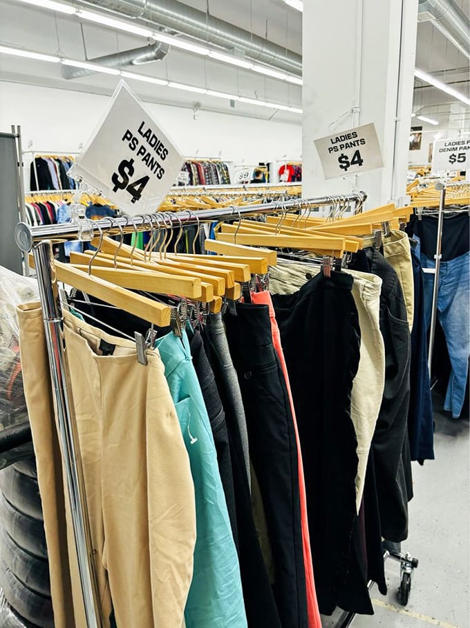 Ladies' pants organized by size and style—because even secondhand shopping deserves first-class organization and respect.