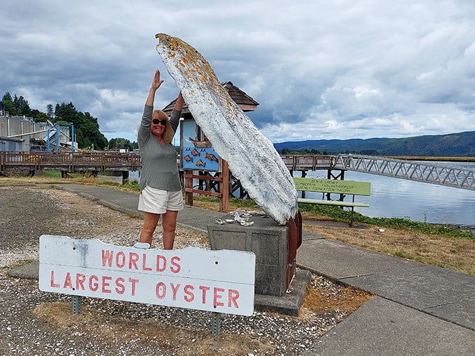 Victory pose achieved—because conquering the World's Largest Oyster absolutely deserves a celebratory snapshot for the photo album.