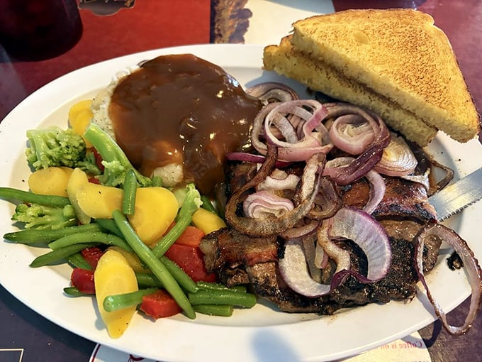 Liver and onions with mixed vegetables and mashed potatoes—a plate that would make your grandmother nod in solemn approval.