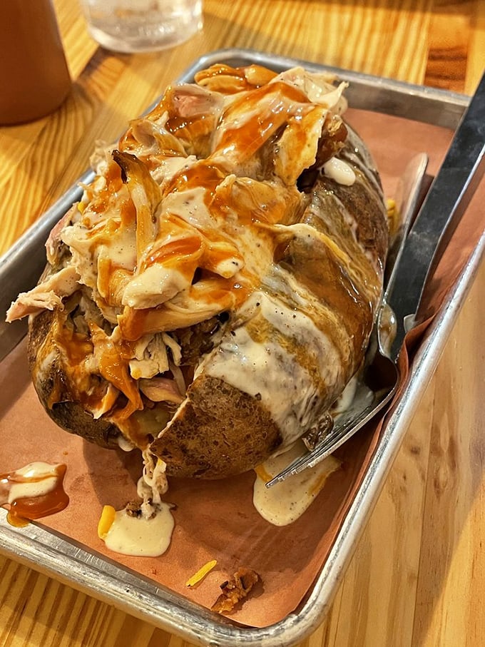 Not just any potato—a smoke-infused vessel carrying pulled chicken, sauce, and dreams. Spuds have never had it so good. 