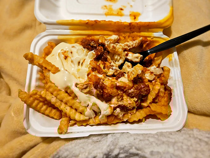 These aren't just loaded fries—they're a masterpiece of excess. That cheese sauce flows like lava over a landscape of perfectly crisp potatoes.
