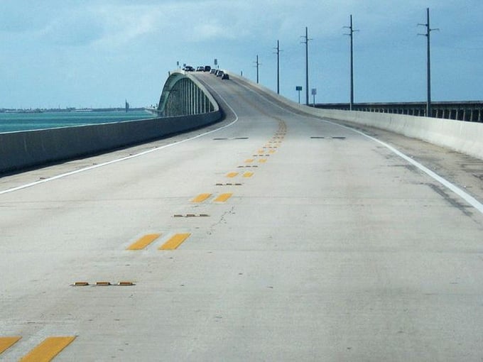 The gentle arch of this bridge creates that roller-coaster-in-slow-motion feeling that tells you you're officially on island time now.