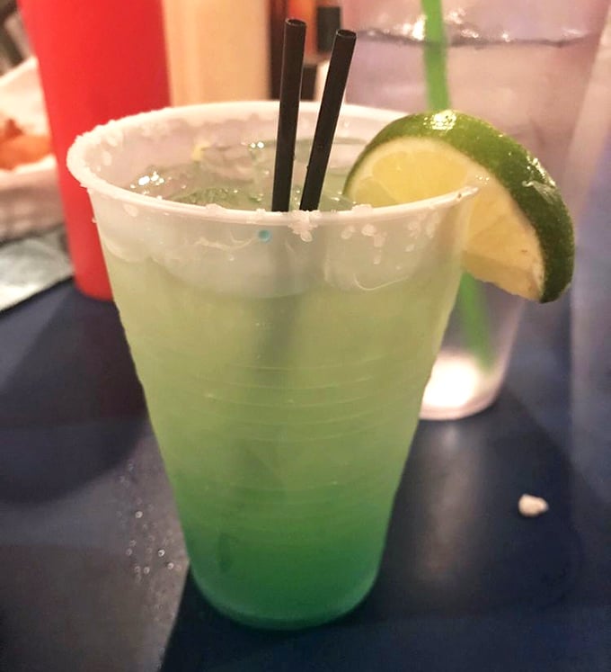 This electric blue margarita isn't just a drink – it's a vacation in a plastic cup. One sip and you're mentally collecting seashells on some distant shore.