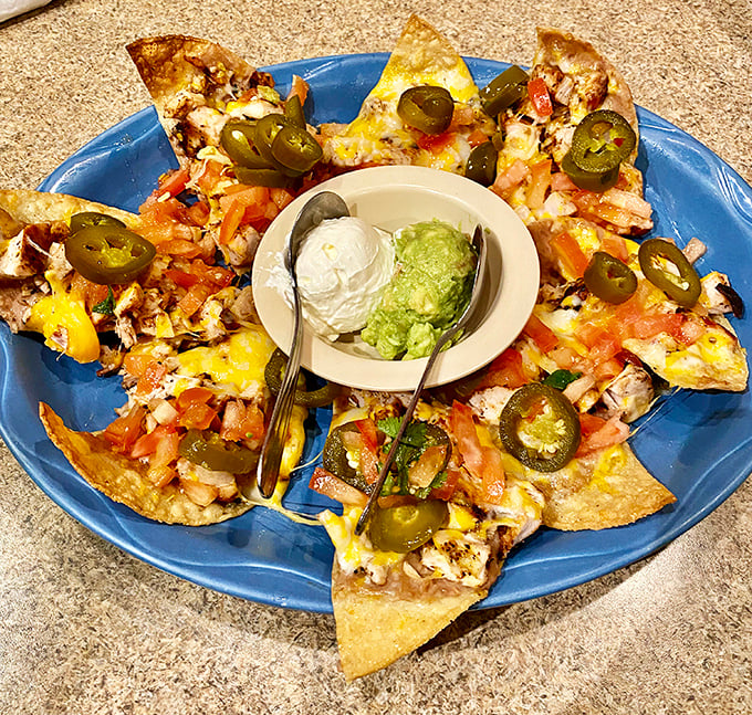 Nachos arranged in a perfect circle, like a Mexican sun with jalapeño rays. That central duo of sour cream and guacamole is calling your name.