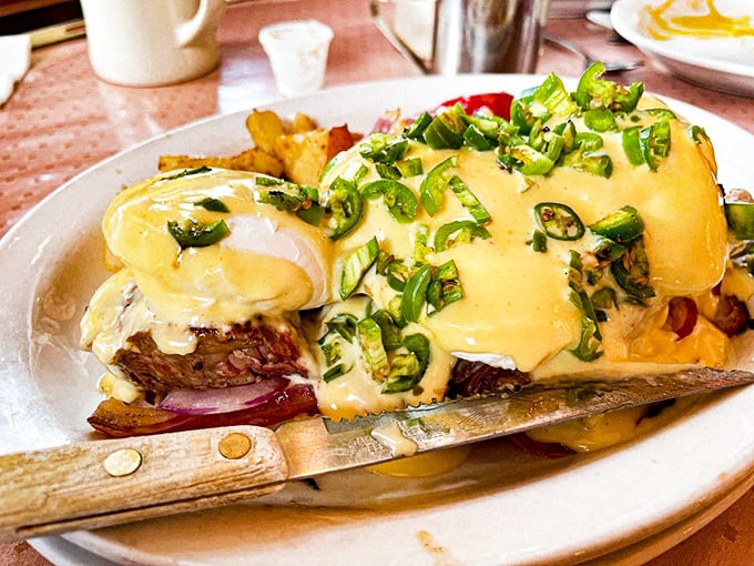 Eggs Benedict arrives dressed to impress, with hollandaise sauce flowing like golden silk over perfectly poached eggs.