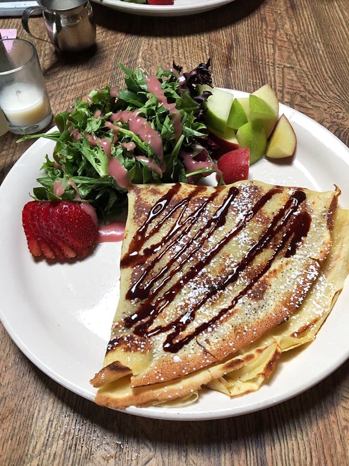 A crepe drizzled with chocolate, surrounded by fresh fruit—proof that sometimes the simplest pleasures are the most profound. Dessert or breakfast? Yes.