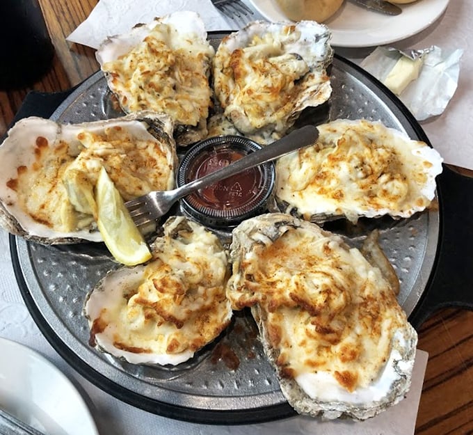 Oysters Rockefeller done right—these bivalves wear their creamy, cheesy topping like formal attire at a Chesapeake Bay gala.