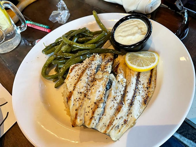 The Ozarks Trout Almondine proves that sometimes simple is spectacular – delicate fish, crisp green beans, and a squeeze of lemon is all you need.