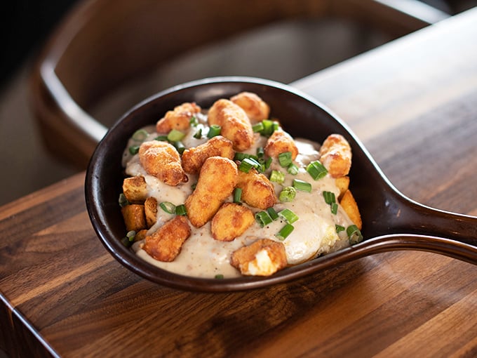 Tater tots and gravy in a skillet—proof that sometimes the best ideas are the ones that make you wonder why you didn't think of them first.