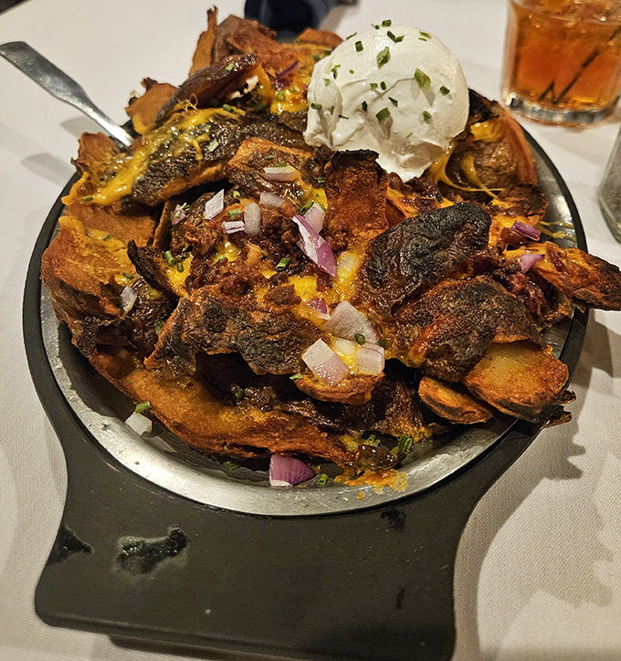 Loaded nachos reimagined with prime rib – a glorious mountain of indulgence that makes sharing feel like a genuine sacrifice.