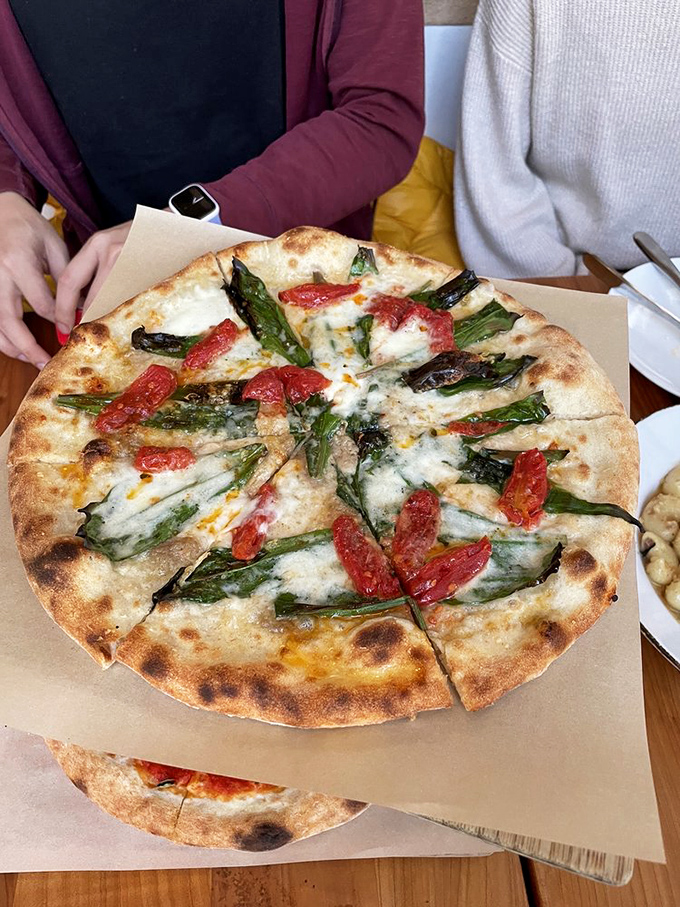 Spring on a pizza—asparagus and tomatoes playing nicely together on a canvas of perfect crust and melted cheese.