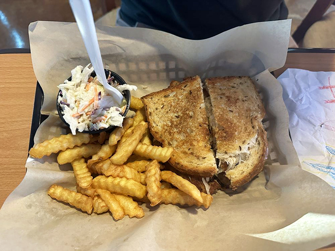 A sandwich and fries served in a basket lined with paper—the universal signal that you're about to experience something honest, unpretentious, and utterly satisfying.