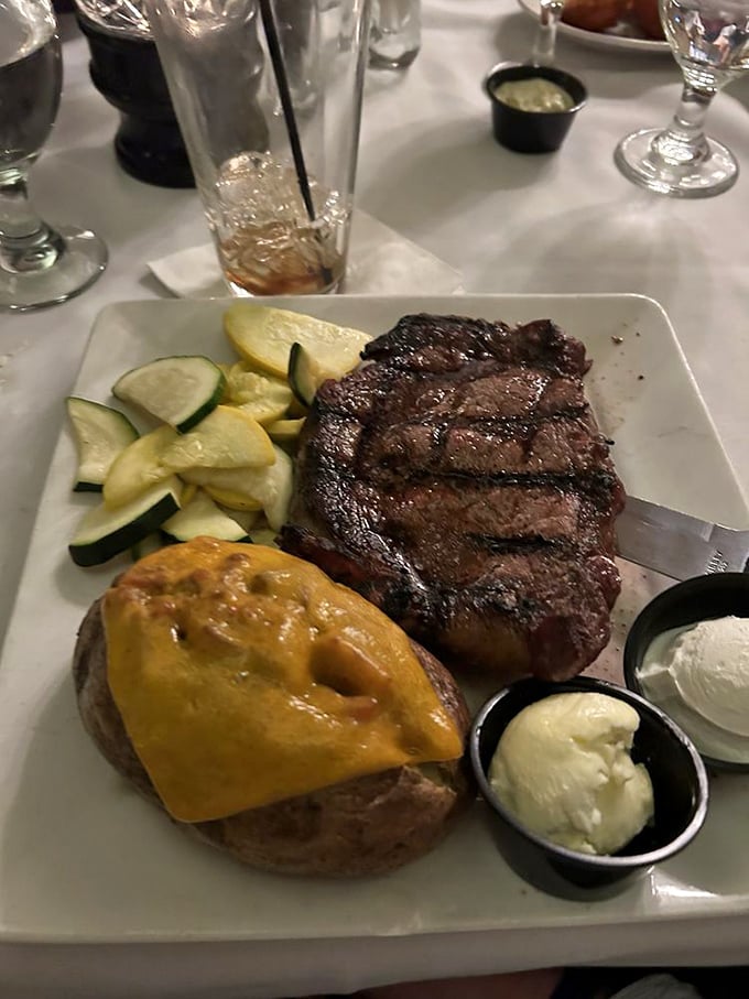 This ribeye doesn't need Instagram filters—it's naturally photogenic. Perfectly charred exterior, rosy interior, and sides that know their supporting role in this meaty blockbuster.