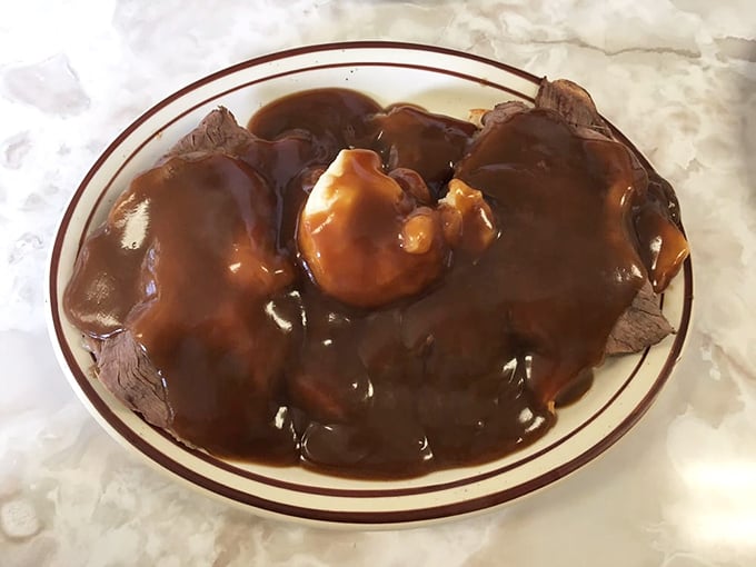 When gravy cascades over roast beef like this, you don't just eat lunch—you experience a moment of pure, unadulterated American culinary bliss.