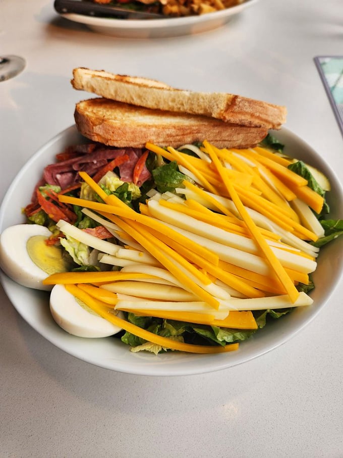A chef's salad that doesn't apologize for being a salad – it stands proud with its rainbow of cheese, protein, and vegetables.