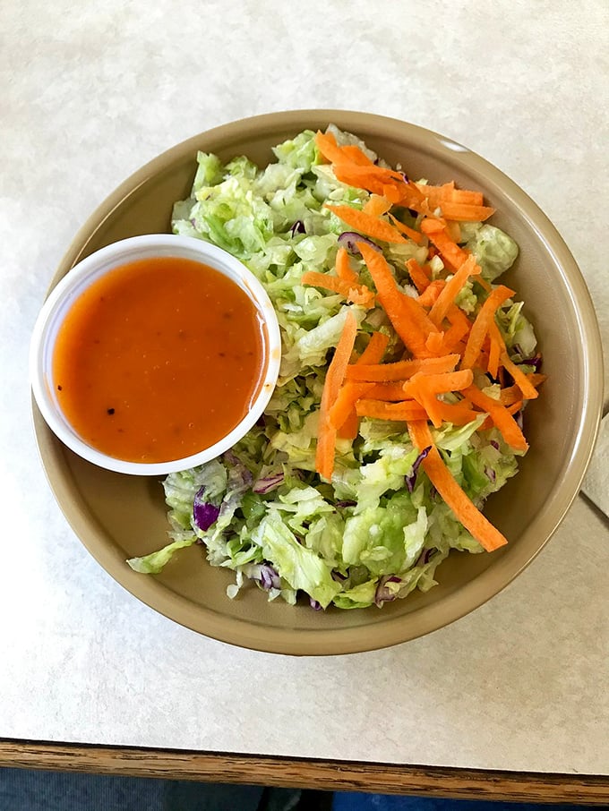Even the salad gets special treatment here. Fresh, crisp, and colorful – the perfect counterpoint to all that glorious fried goodness.