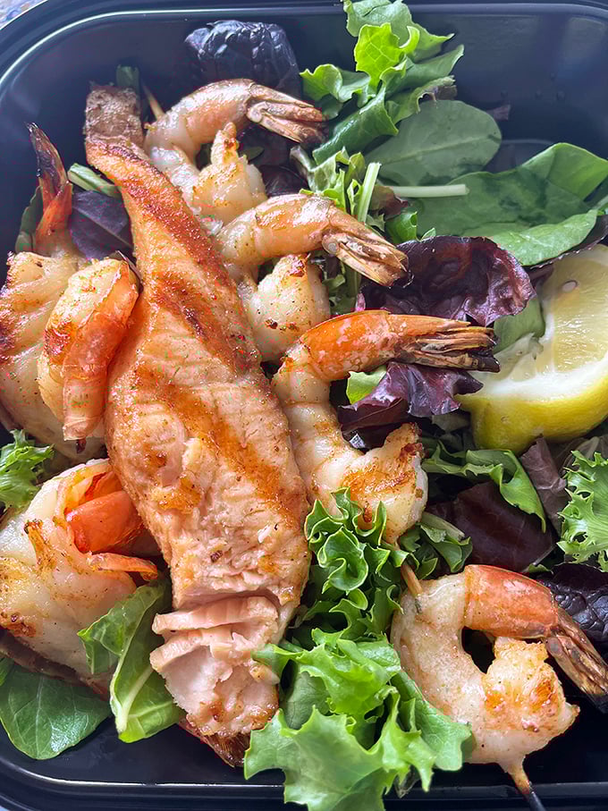 Grilled shrimp perched on fresh greens—proof that you can have your health food and enjoy it too.
