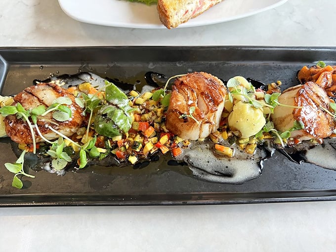 These scallops aren't just seared—they're transformed into caramelized jewels of the sea, surrounded by a colorful confetti of vegetables.