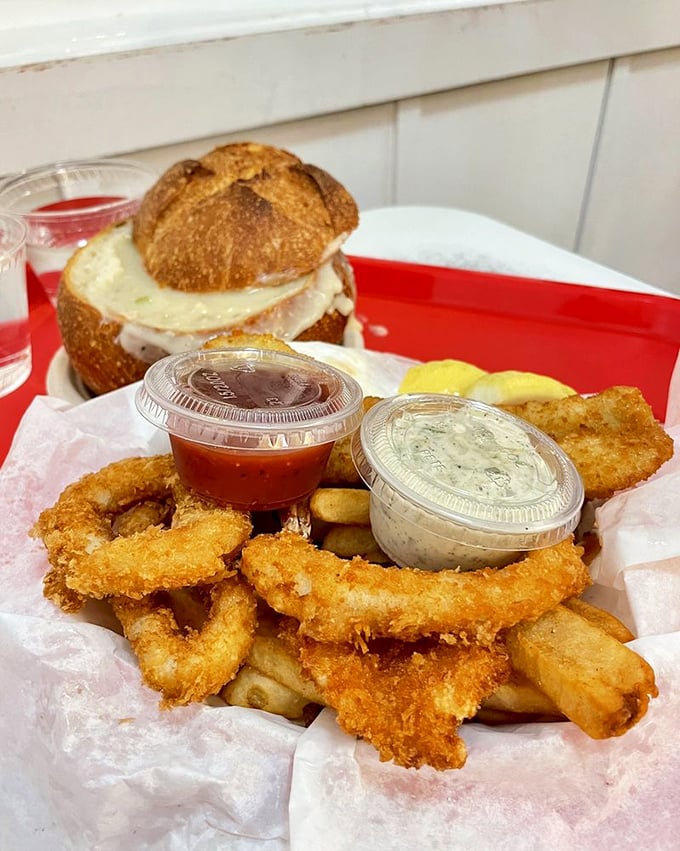 A seafood platter that doubles as a love letter to the ocean – crispy onion rings, tender seafood, and dipping sauces galore.