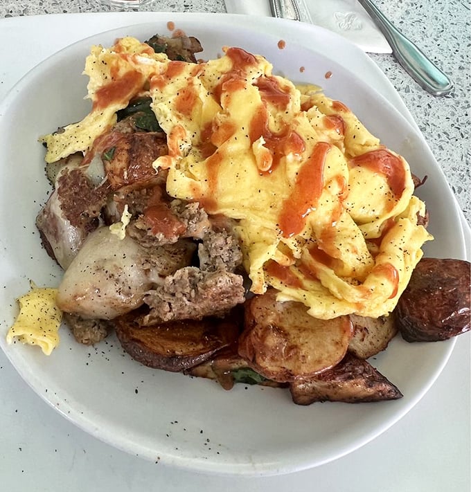 This skillet doesn't just contain breakfast—it's hosting a summit meeting where eggs, meat, and potatoes have gathered to solve world hunger, starting with yours.