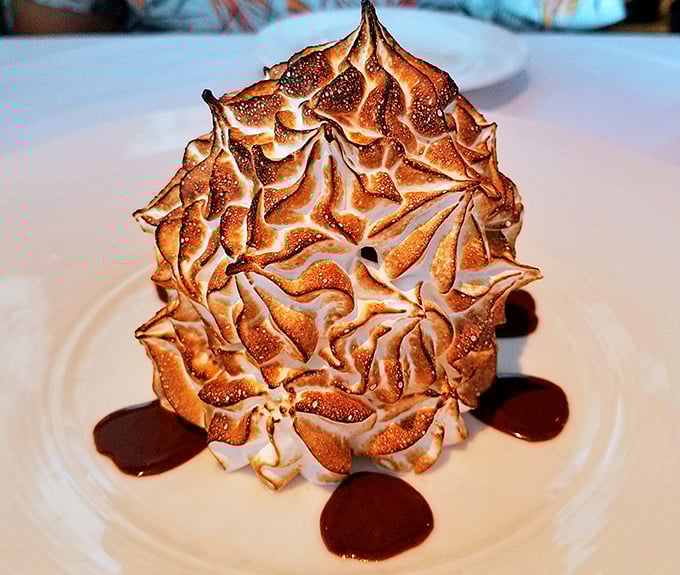 The Baked Alaska's perfectly toasted peaks look like a meringue mountain range I'd happily climb without oxygen tanks. Dessert drama at its finest.