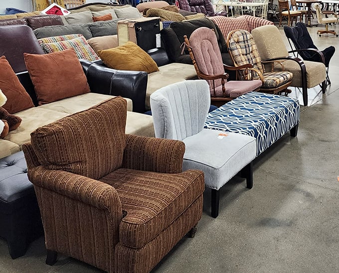 The furniture section—a comfortable purgatory where sofas and armchairs wait for their second chance at witnessing family movie nights.