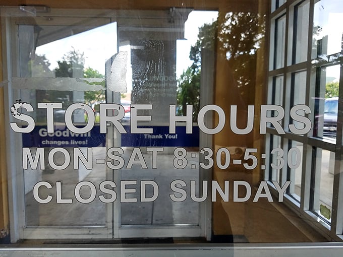 The store hours sign—a crucial piece of intelligence for planning your thrifting mission. Early birds catch the best merchandise before the weekend warriors arrive.
