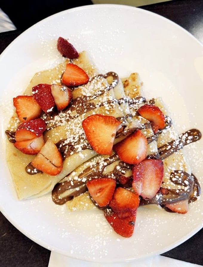 Strawberry Nutella crepe that makes French diplomacy look easy—a delicate balance of sweet, tart, and chocolate that deserves its own peace treaty.