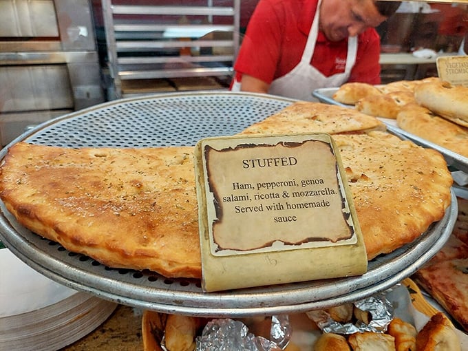 The stuffed pizza sits proudly on display, its golden exterior hiding treasures within like a delicious pirate chest filled with meaty, cheesy doubloons.