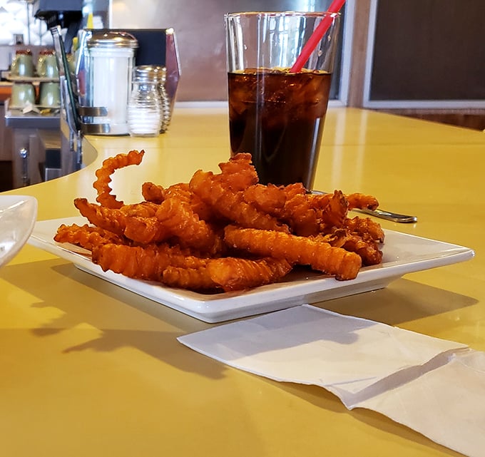 Curly fries with personality—twisted, golden, and crispy enough to make you forget your table manners entirely.