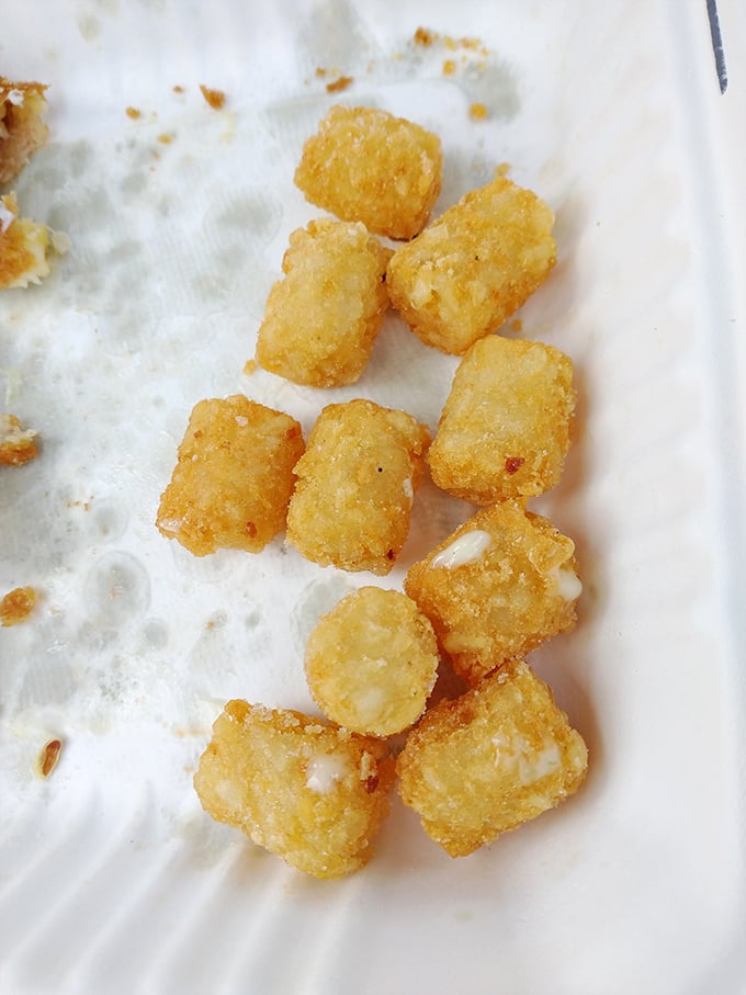 These golden tots aren't just potato nuggets—they're crispy little time machines that transport you back to the best school lunch you never had.