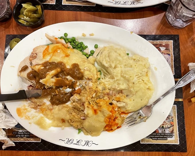 This isn't just turkey dinner—it's Thanksgiving without the relatives, a plate piled high with comfort that whispers "nap time" with every bite.