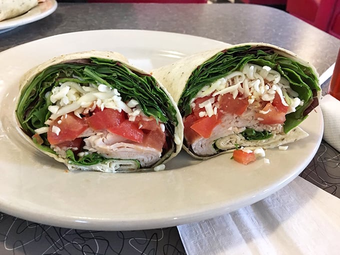 A wrap that actually stays wrapped—fresh greens, tomatoes and cheese in perfect harmony, ready for its close-up before disappearing forever.