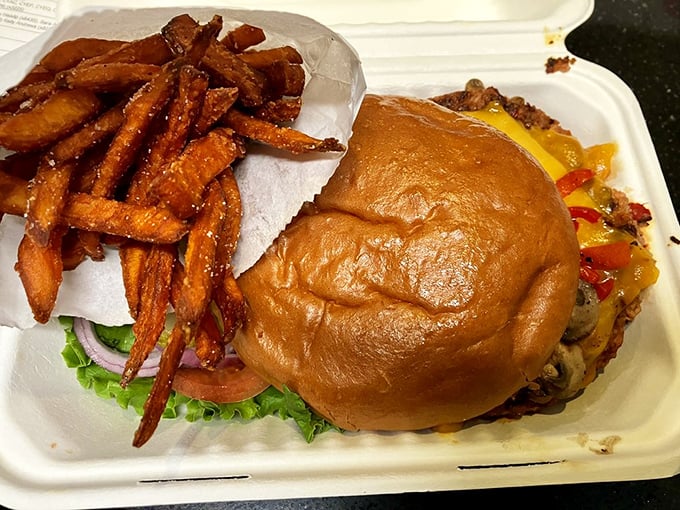 Even vegetarians get the royal treatment—this veggie burger with sweet potato fries proves plant-based doesn't mean pleasure-free.