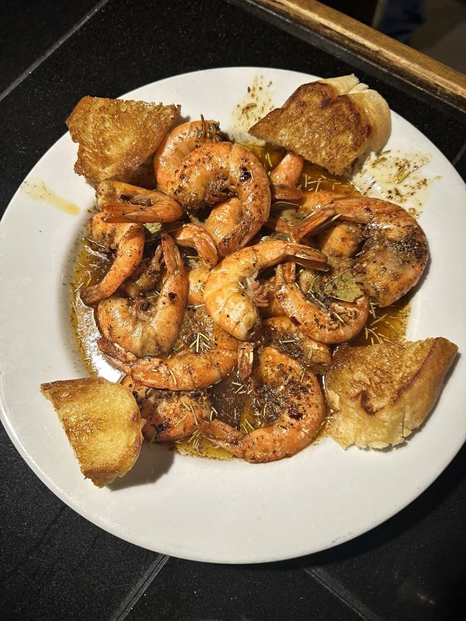These shrimp swimming in garlicky butter with crusty bread lifeboats are proof that sometimes the simplest preparations create the most profound flavors.