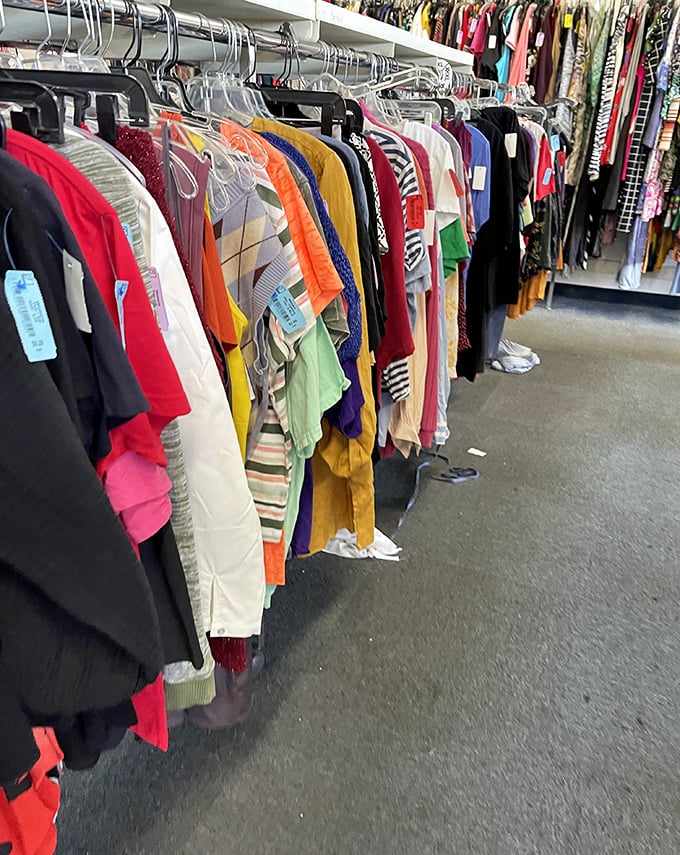 The rainbow road of retail therapy—racks of colorful clothing where yesterday's fashion statements become tomorrow's vintage finds.