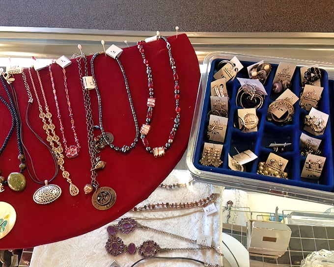 Jewelry that tells stories—previous lives sparkle on red velvet displays. Someone's forgotten statement piece becomes your new conversation starter.