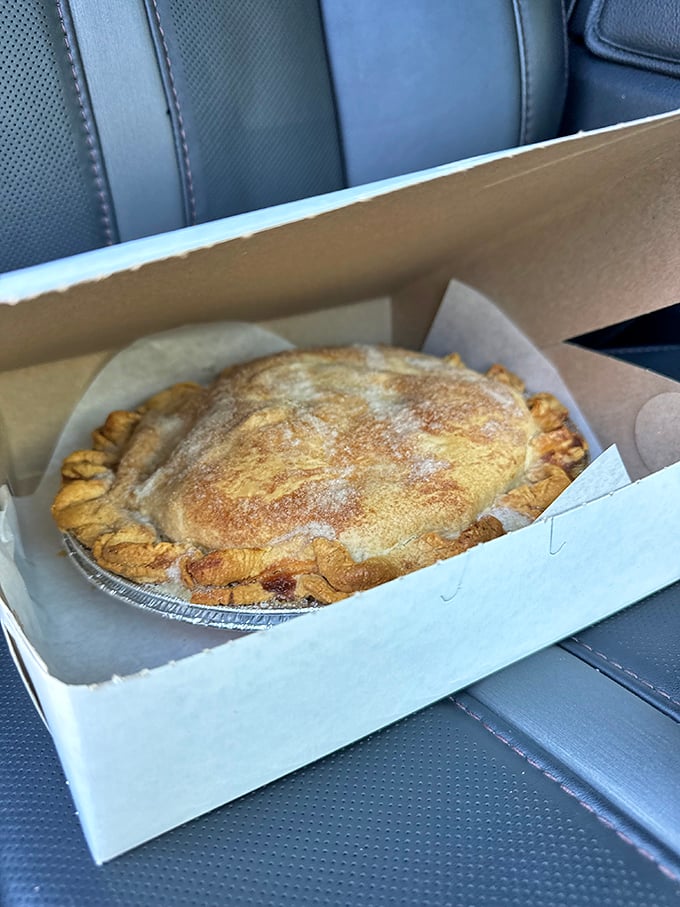 Not all heroes wear capes—some wear golden, flaky crusts. This apple pie, boxed and ready for transport, is about to make someone's day.