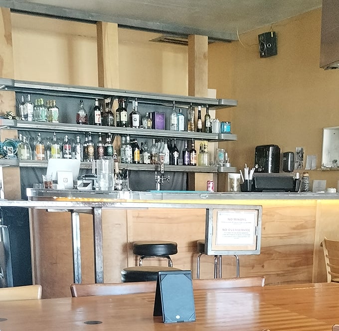 The bar area hints at Shakabrah's dual personality—morning breakfast haven transforms into evening hangout spot as the day progresses.