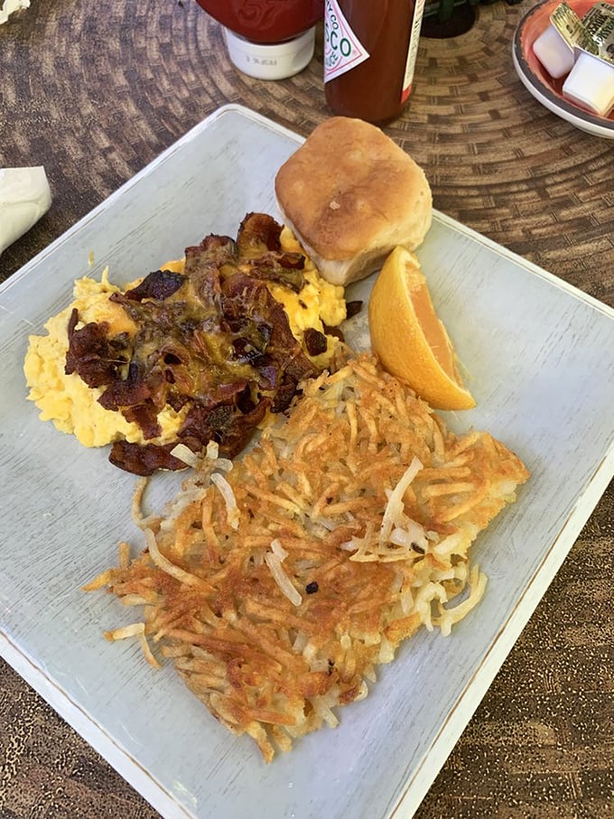 Scrambled eggs, crispy hashbrowns, and a biscuit—the breakfast trinity that proves simplicity is the ultimate sophistication.