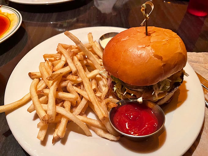 This isn't just a burger, it's an architectural achievement—towering yet stable, with each layer playing its crucial structural and flavor role.